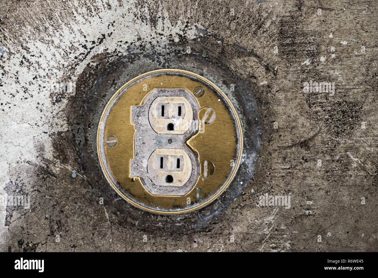 Floor Plug sockets built in to concrete ground, worn concrete floor ...