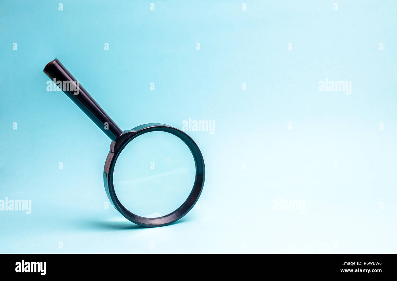 Magnifying glass on blue background. Concept of search and analysis ...