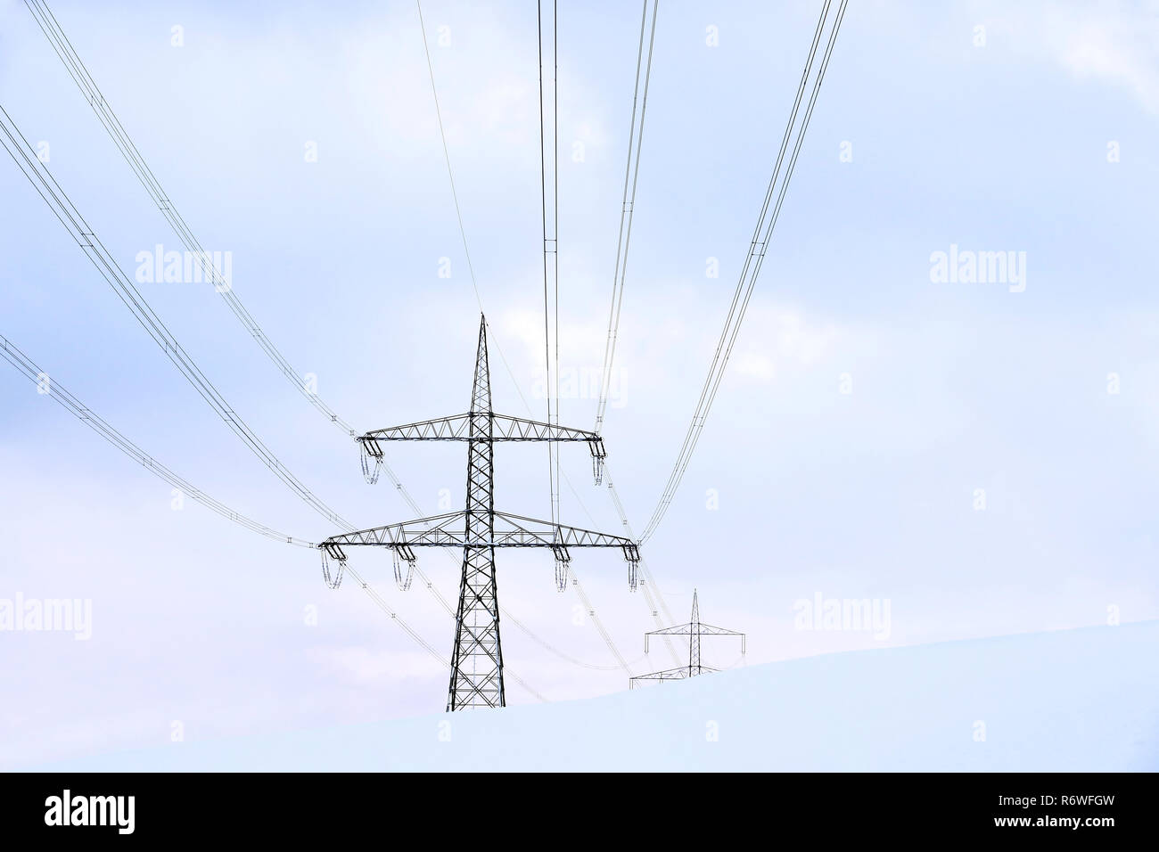 an overhead power pole for winter power supply in the snow Stock Photo ...