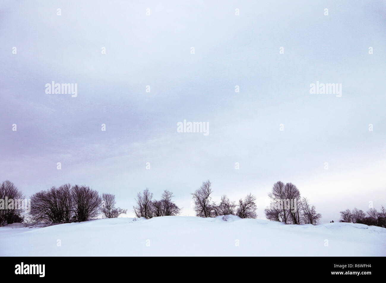a winter landscape with deep snow and cloudy sky Stock Photo - Alamy