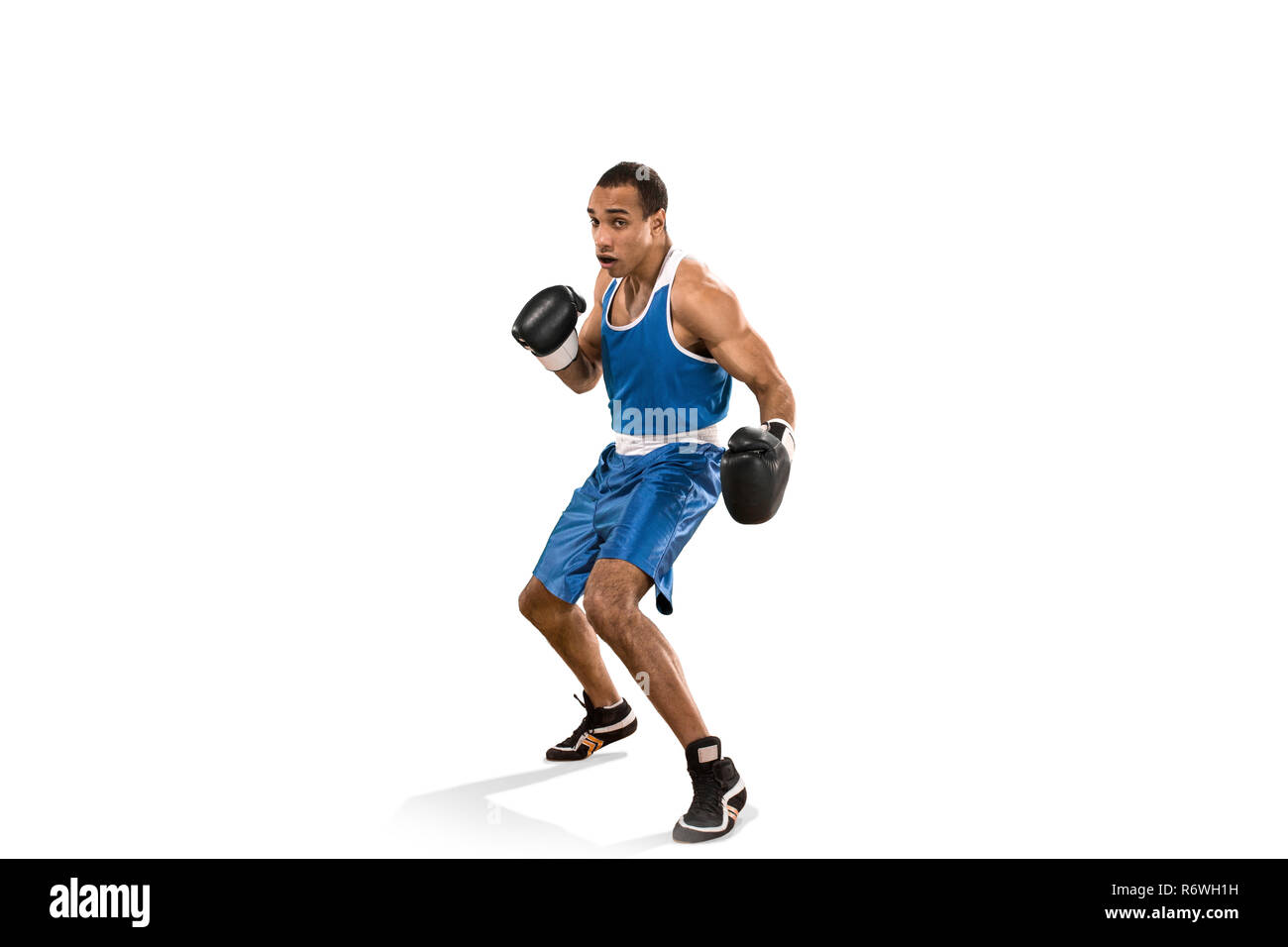 Sporty man during boxing exercise. Photo of boxer on white background ...