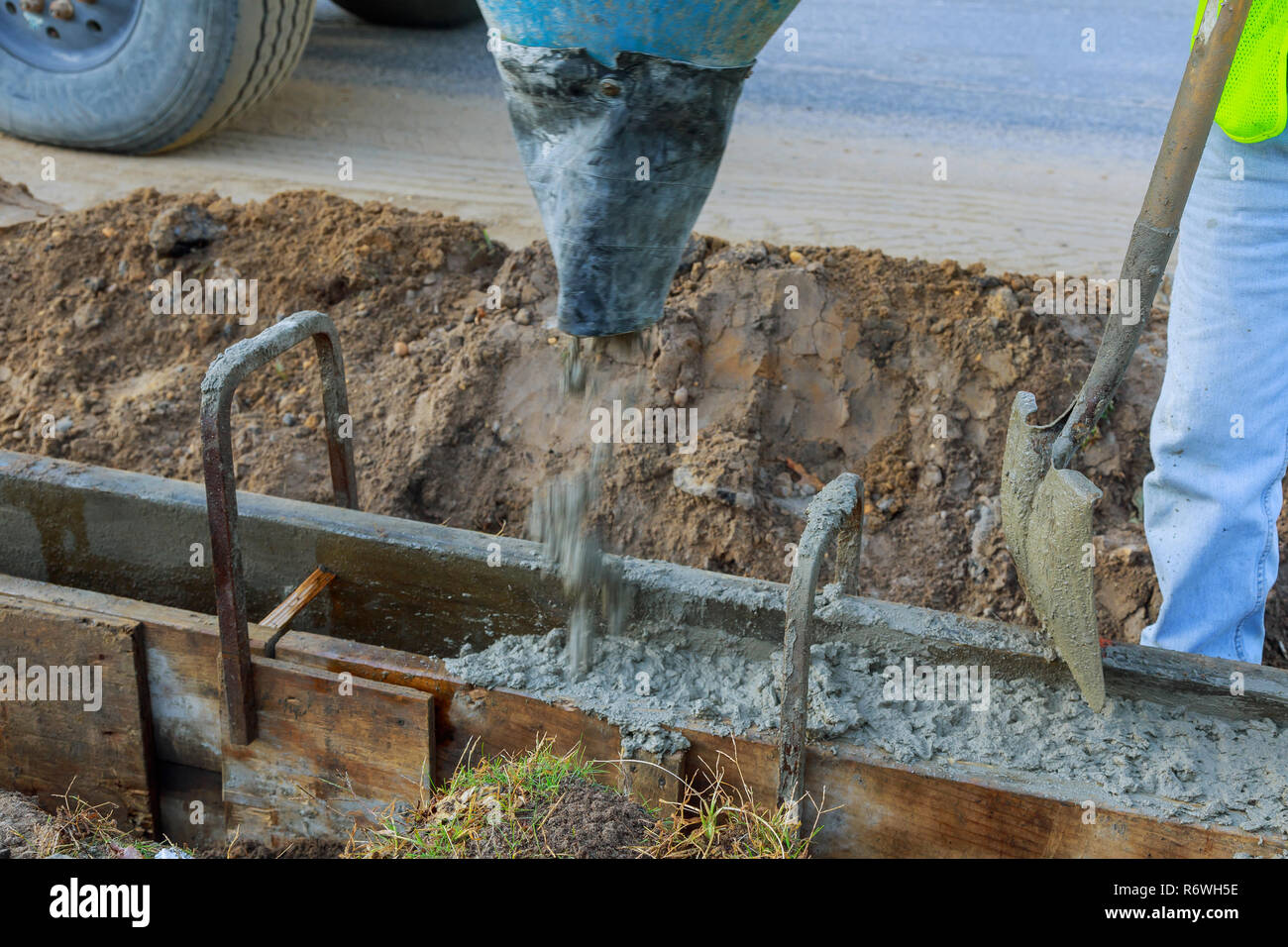 Pouring cement during upgrade to residential street Stock Photo - Alamy