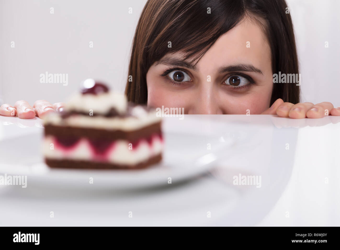 Woman Craving For Slice Of Cake Stock Photo - Alamy