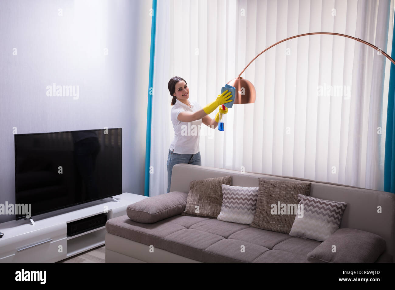 Female Janitor Cleaning Electric Light Stock Photo - Alamy