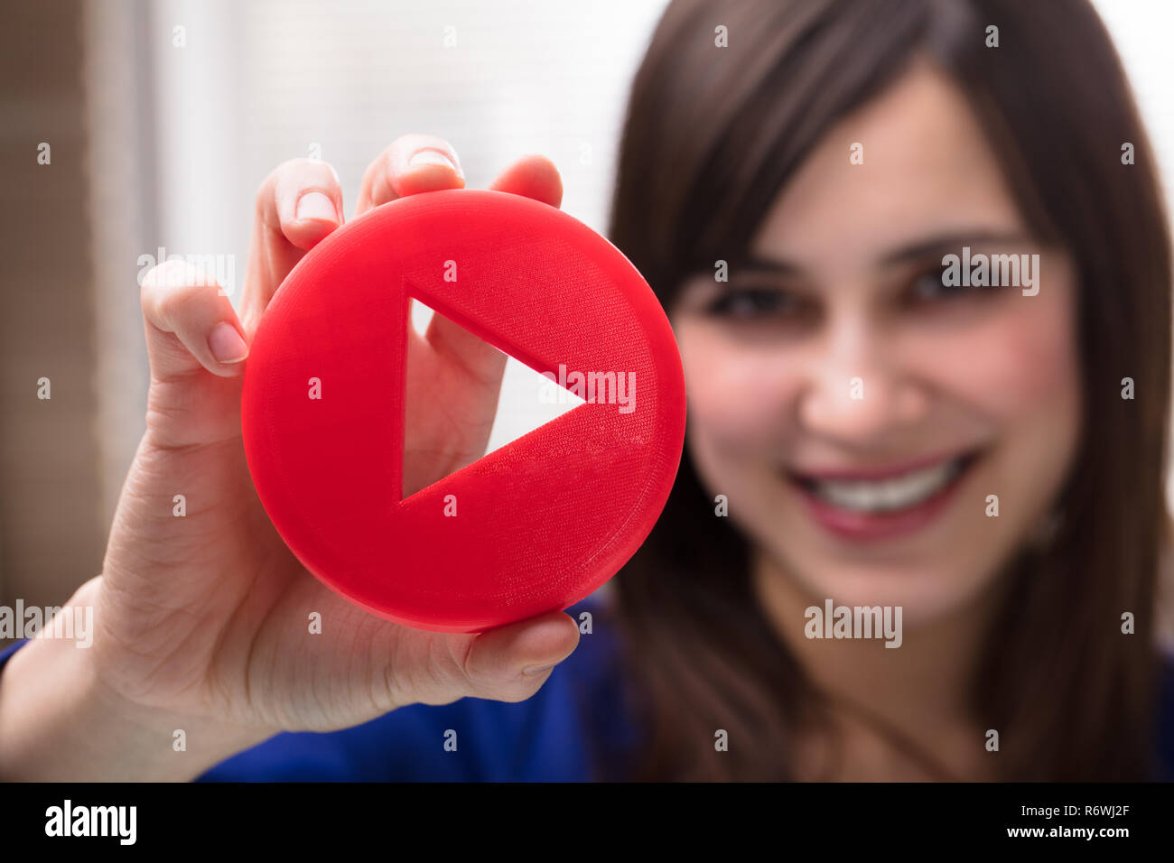 Woman's Hand Holding Play Icon Stock Photo - Alamy