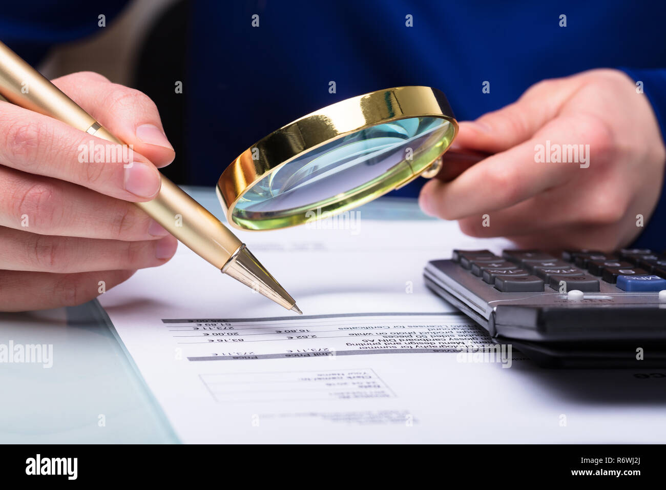 Businessperson Checking Bill Through Magnifying Glass Stock Photo - Alamy