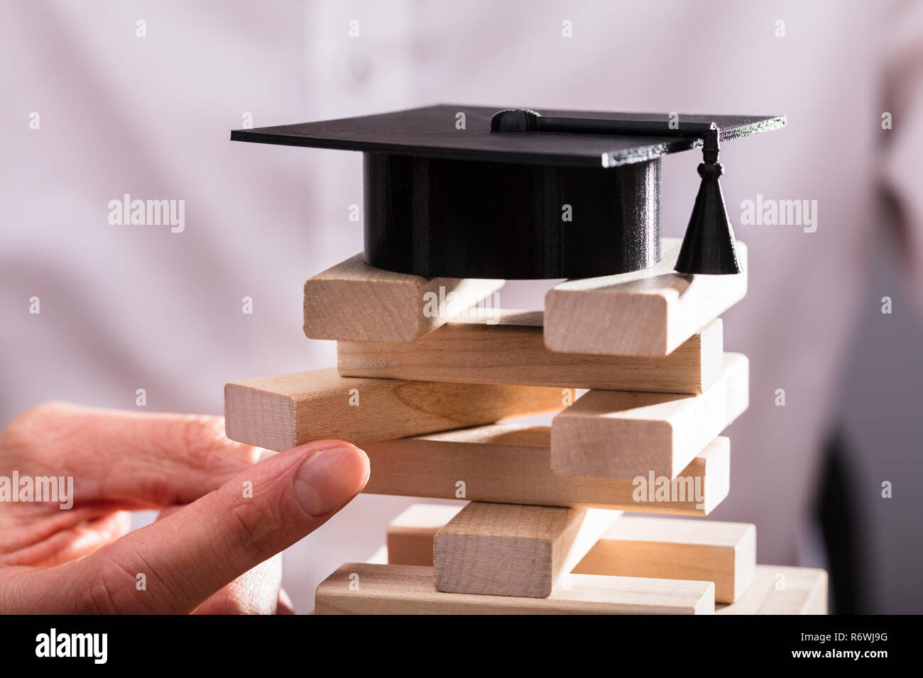 Graduation Hat Over Stacked Wooden Blocks Stock Photo - Alamy