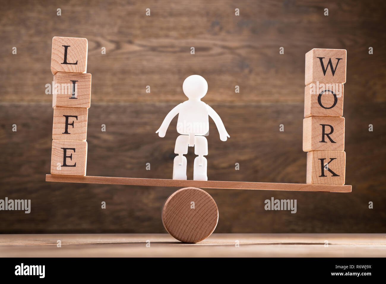 Human Figure Standing Between Work And Life Wooden Blocks Stock Photo ...