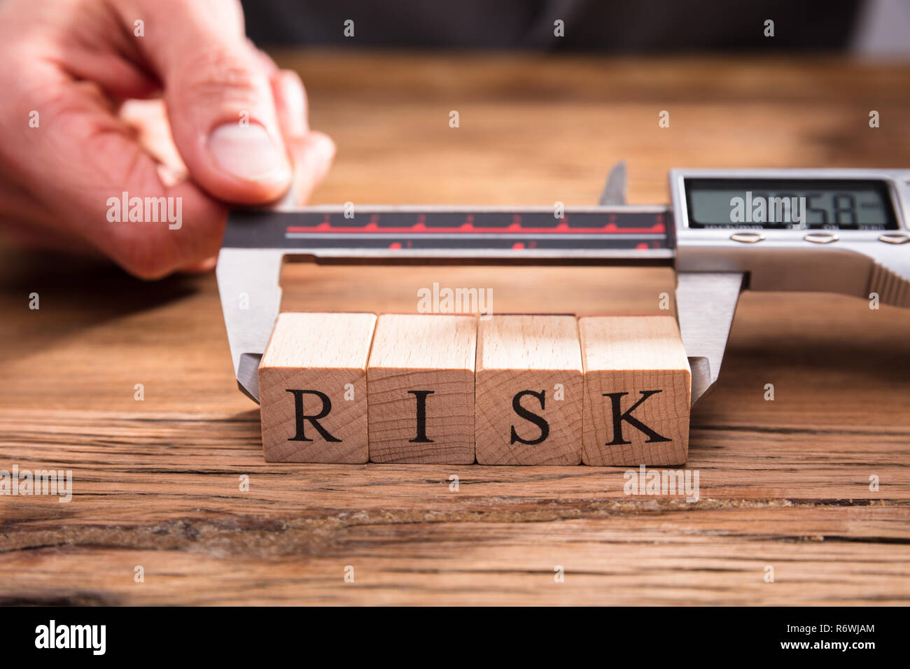 Human Hand Measuring Risk Wooden Blocks Stock Photo - Alamy