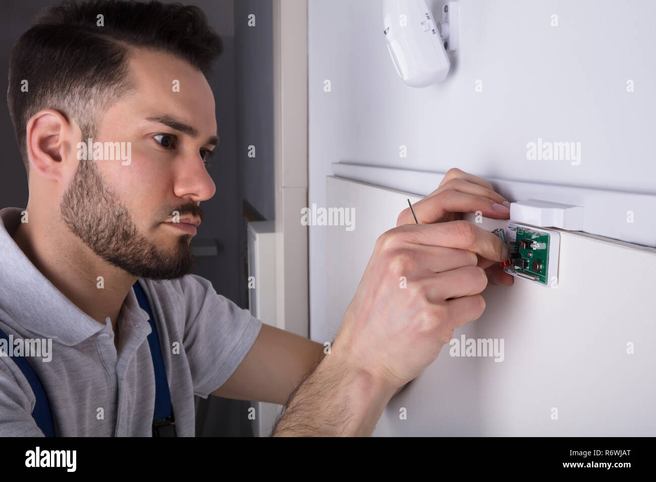 Technician Fixing Security System Door Sensor Stock Photo - Alamy