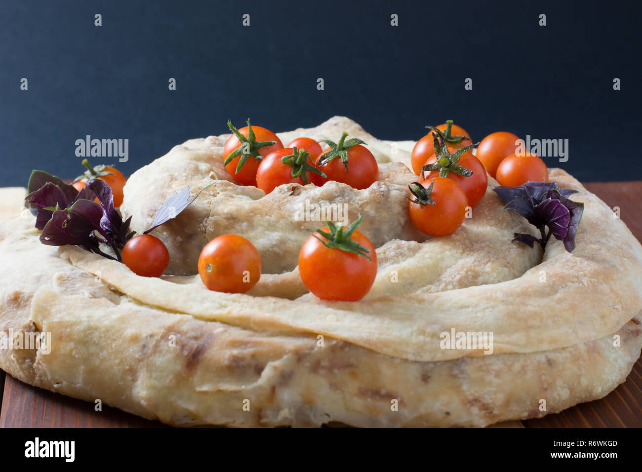 spiral filo pie burek with cherry tomatoes Stock Photo - Alamy