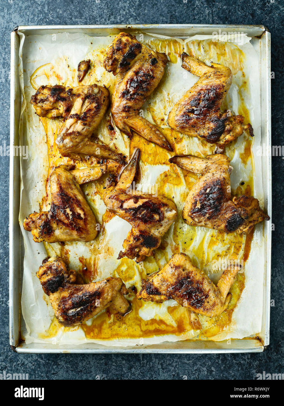 tray of rustic baked chicken wing Stock Photo - Alamy
