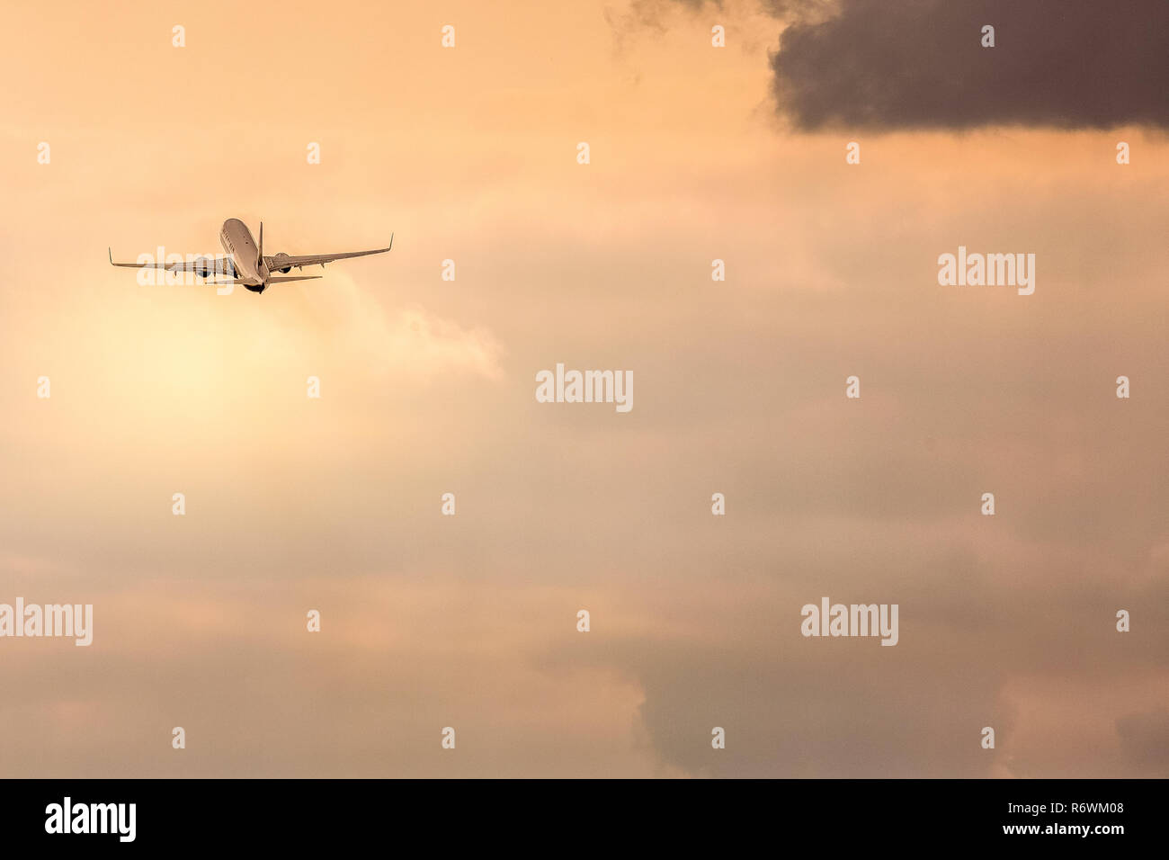 A jet airliner, aeroplane, taking off and heading out in to the sky and ...