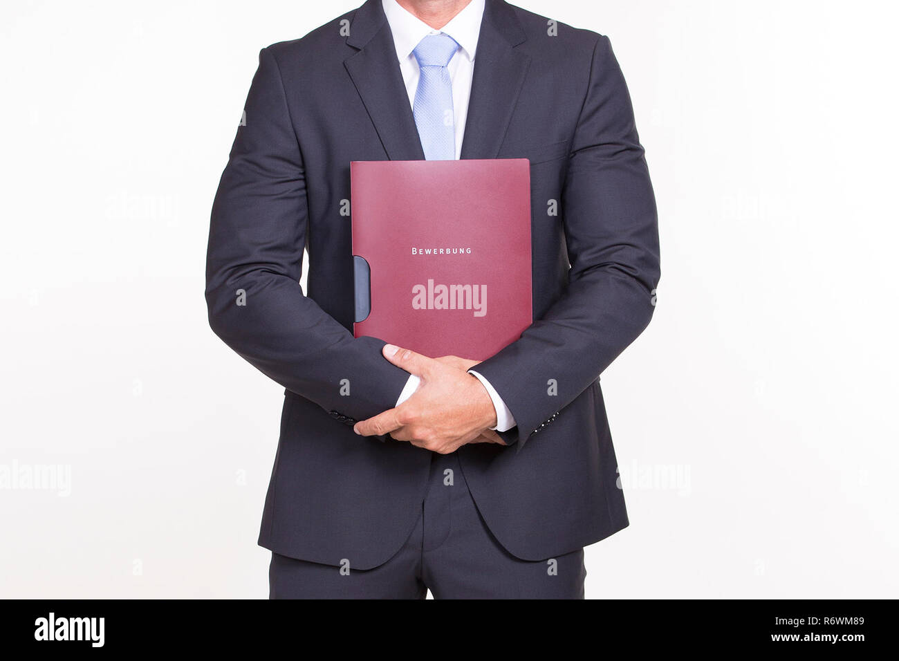 man in suit with application binder Stock Photo - Alamy