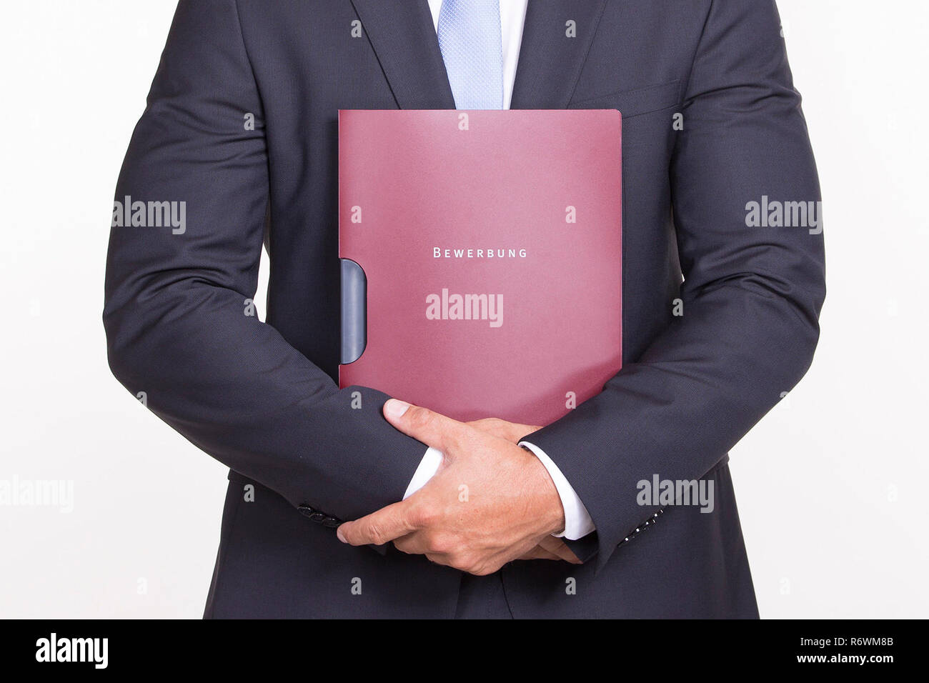 man in suit with application binder Stock Photo - Alamy