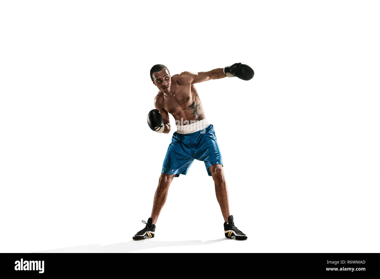 Sporty man during boxing exercise making hit. Photo of boxer on white ...