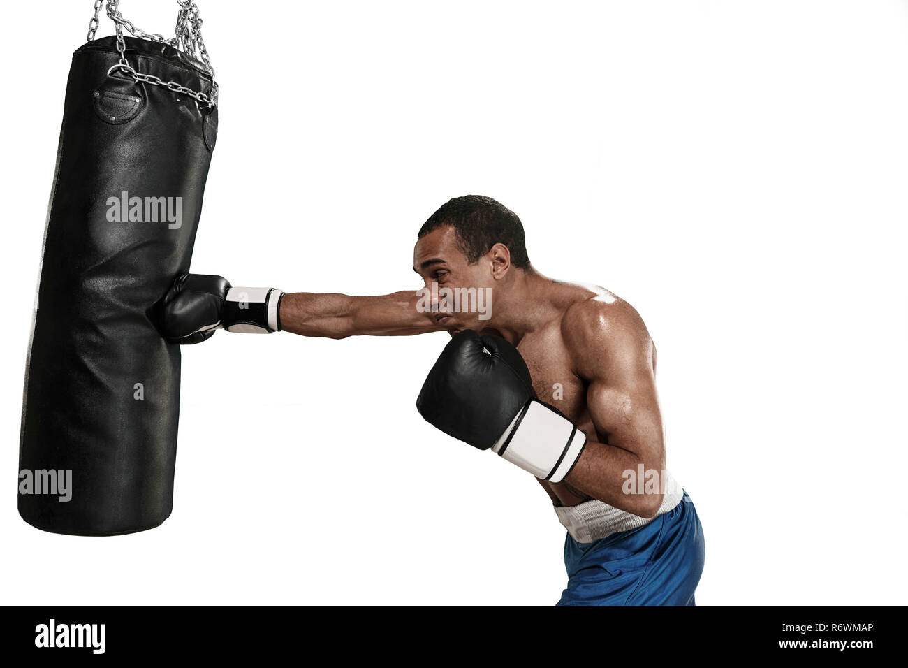 Sporty man during boxing exercise making hit. Photo of boxer on white ...