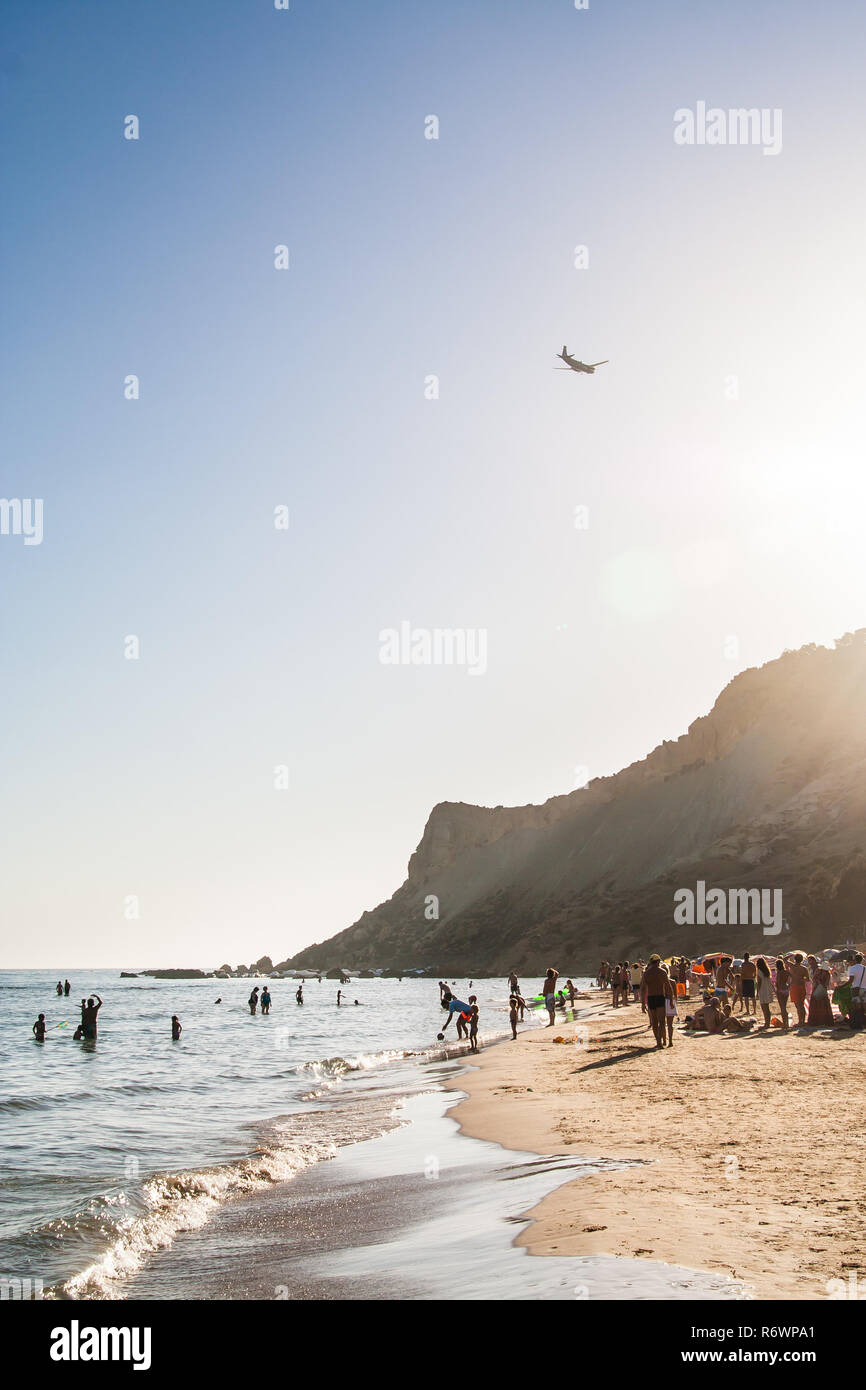 Unidentified people on the beach near white cliff called "Scala dei ...