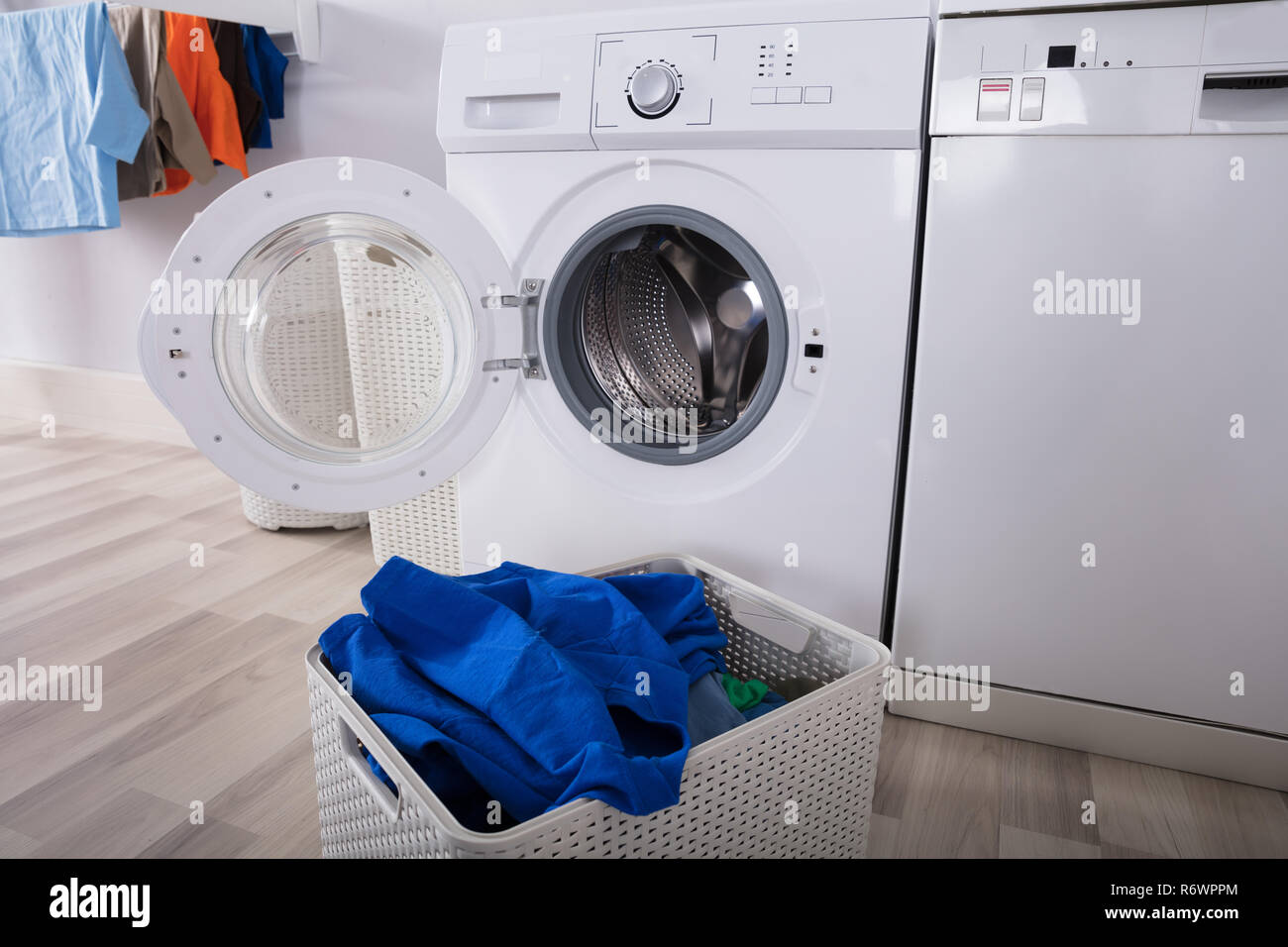 Empty Washing Machine With Pile Of Dirty Clothes Stock Photo - Alamy