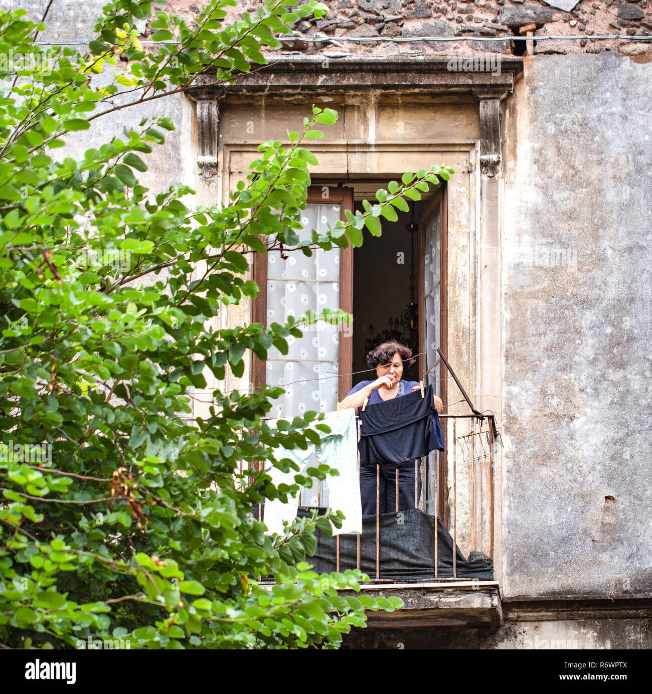 Catania, Sicily Italy - woman hanging out laundry on the balcony Stock ...