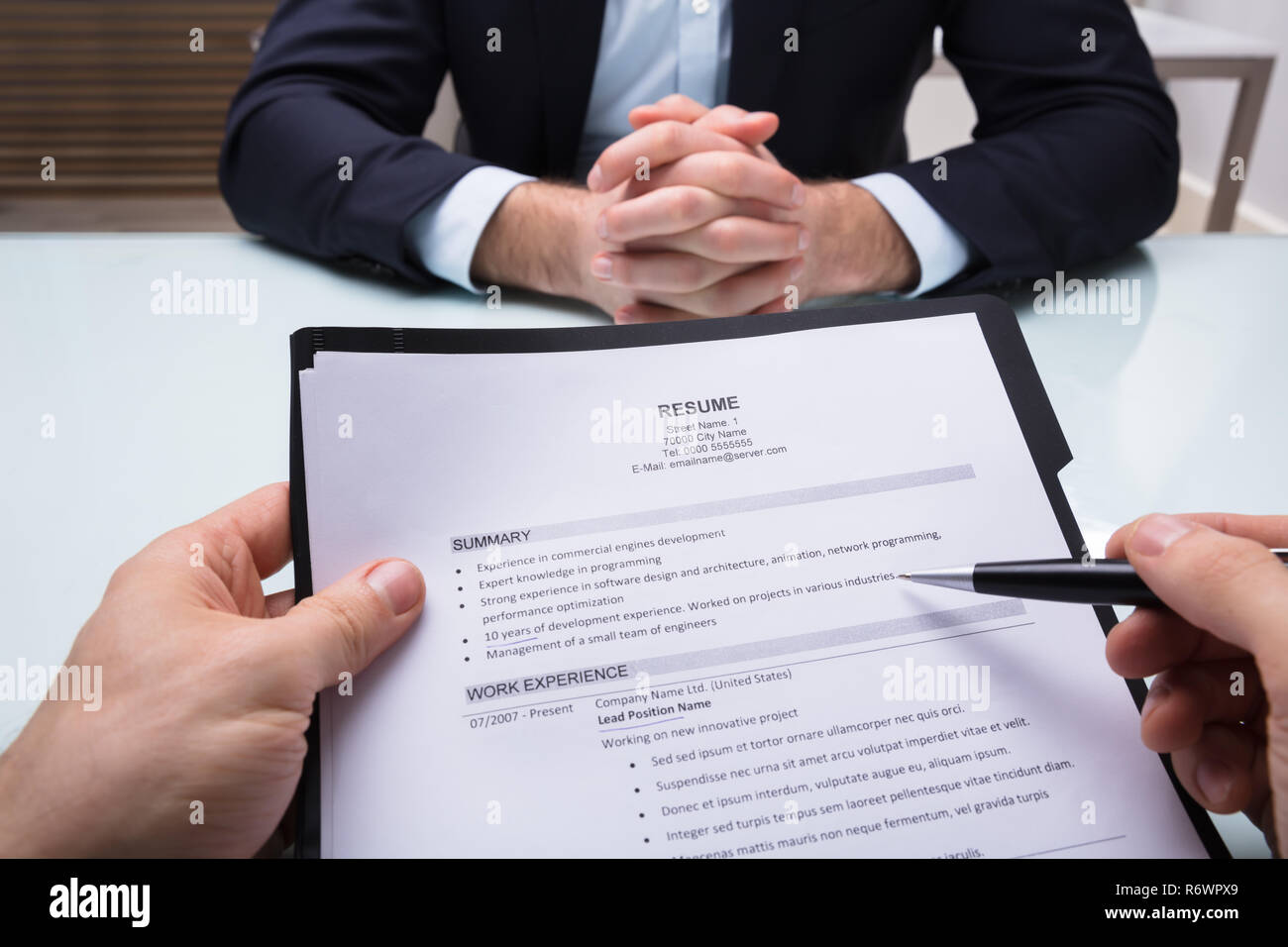 Businessperson's Hand Holding Resume Stock Photo - Alamy