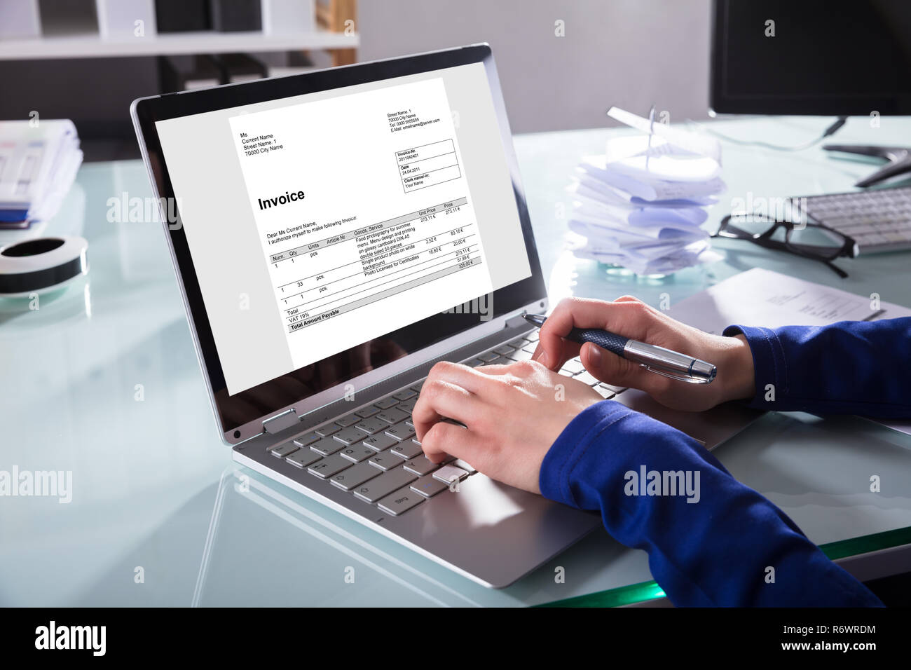 Businessperson Analyzing Invoice On Laptop Stock Photo - Alamy