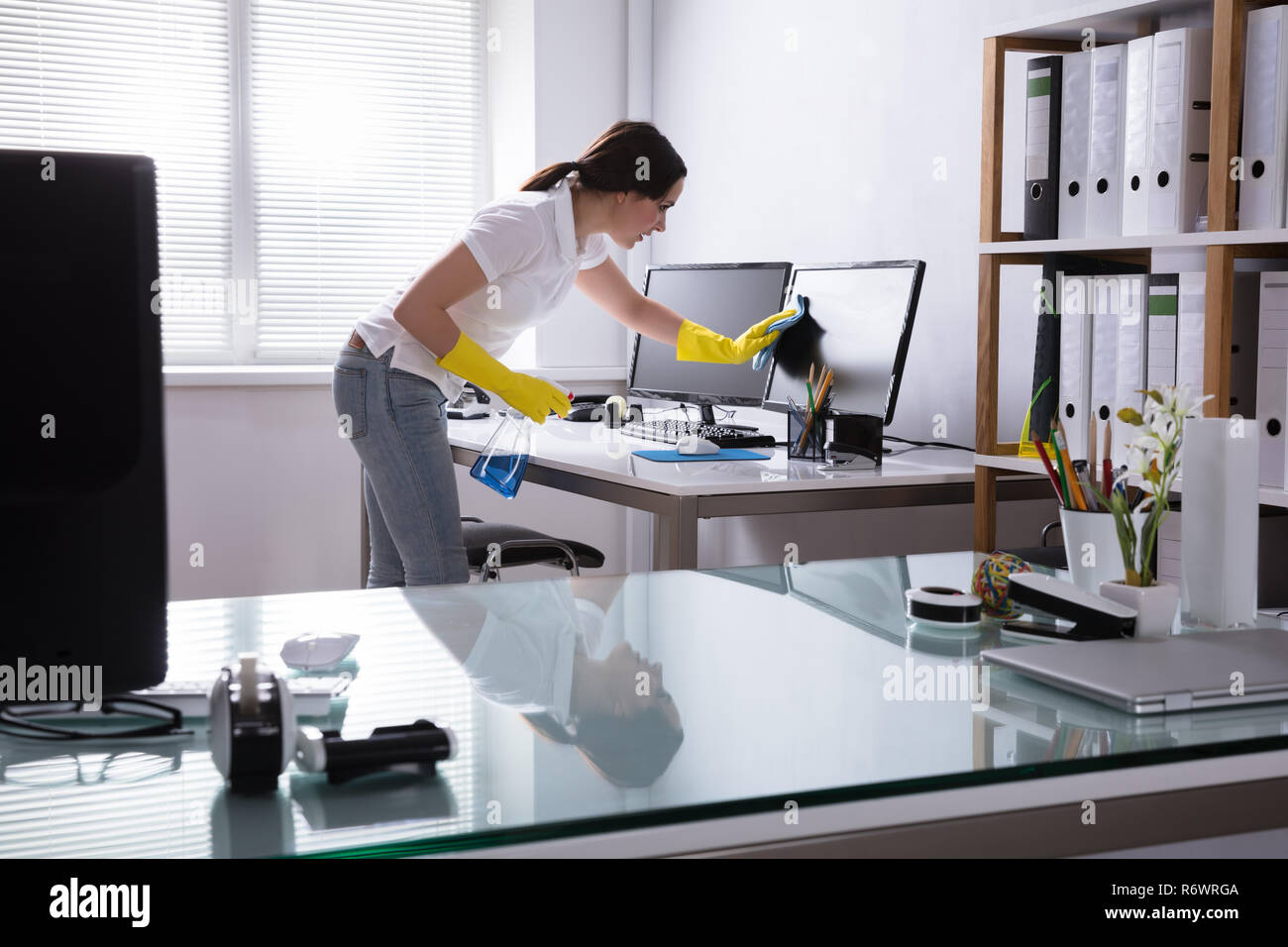 Woman Cleaning Computer In Office Stock Photo - Alamy