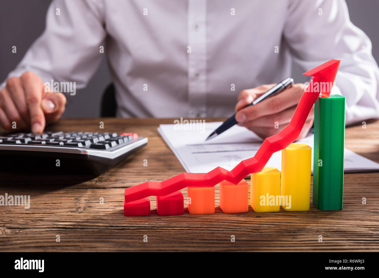 Multi Colored Business Graph With Red Arrow Sign Stock Photo - Alamy