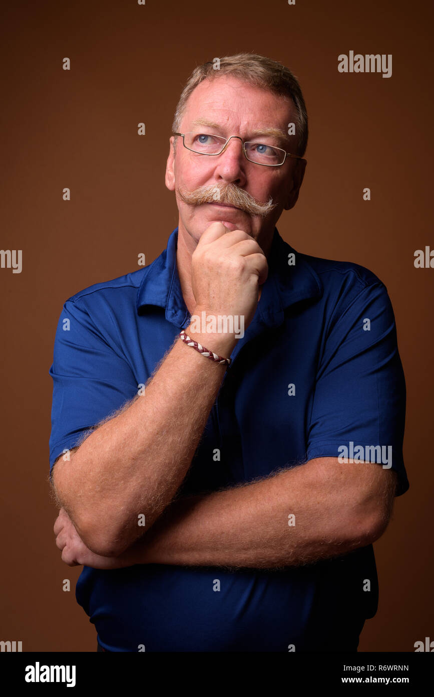 Attractive senior man thinking hi-res stock photography and images - Alamy
