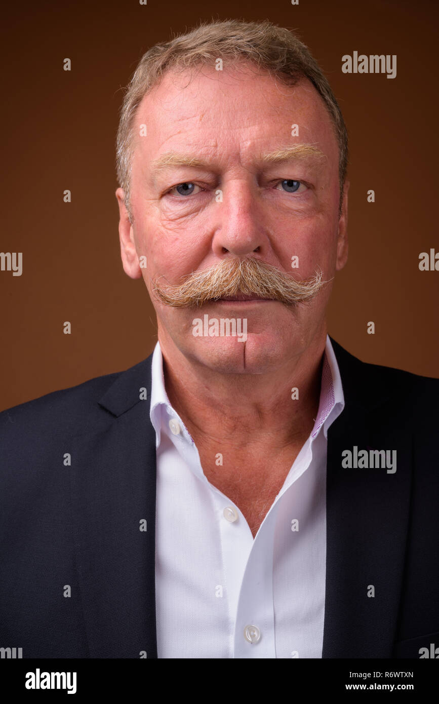 Face of senior businessman with mustache wearing suit Stock Photo - Alamy