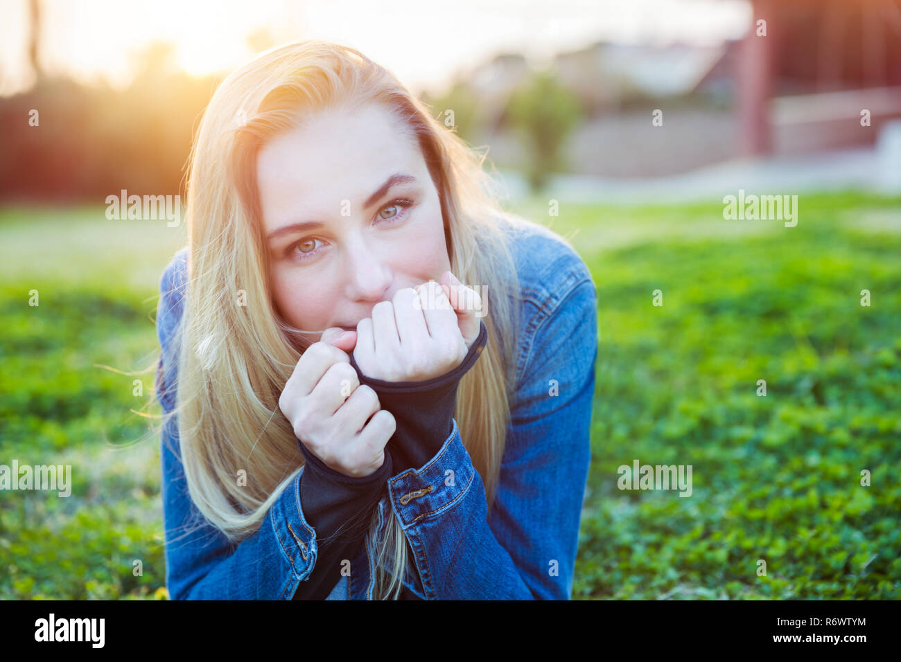 Cute girl on spring meadow Stock Photo - Alamy