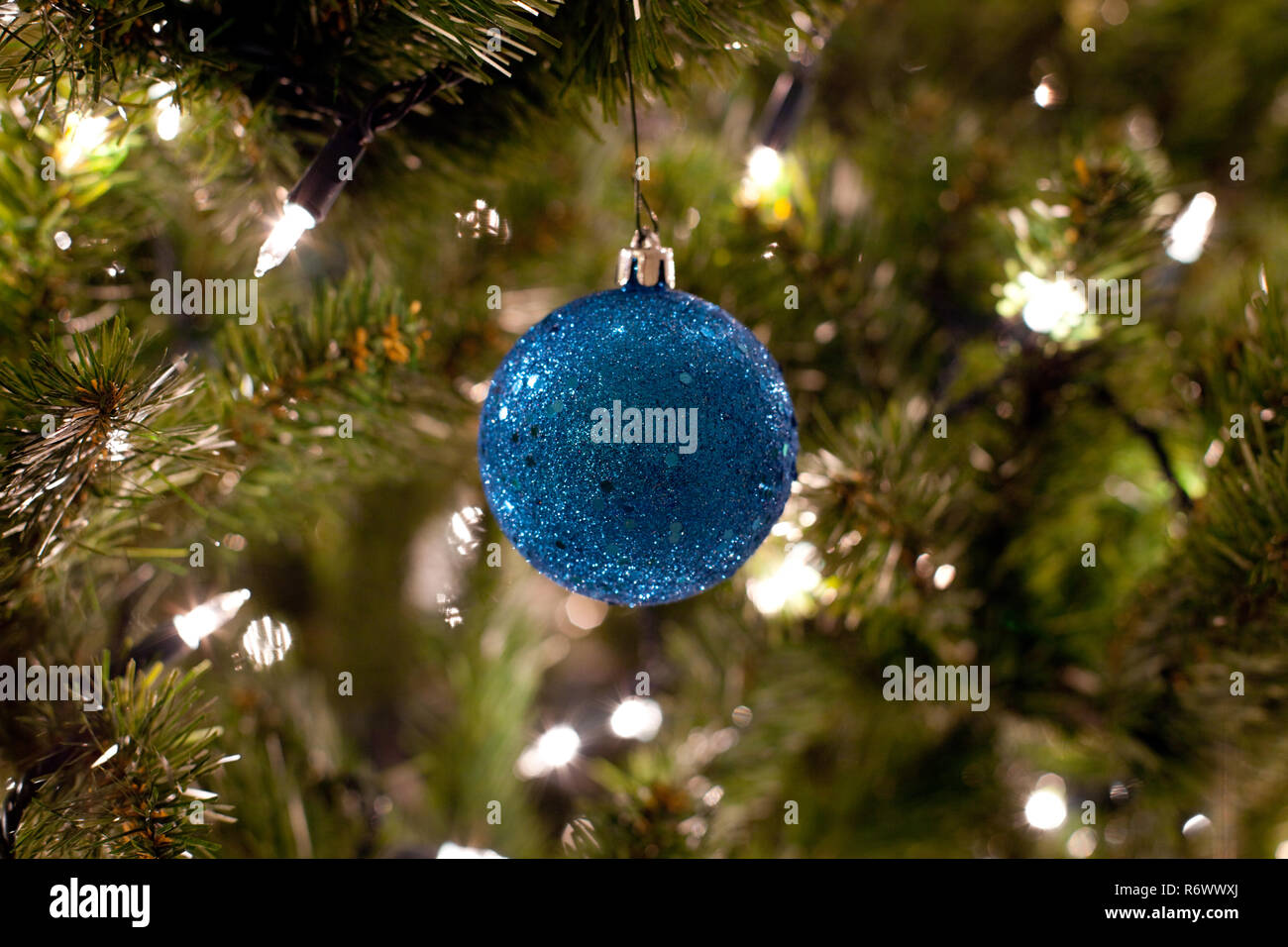 Blue Christmas Ornament on Tree with Lights Stock Photo - Alamy