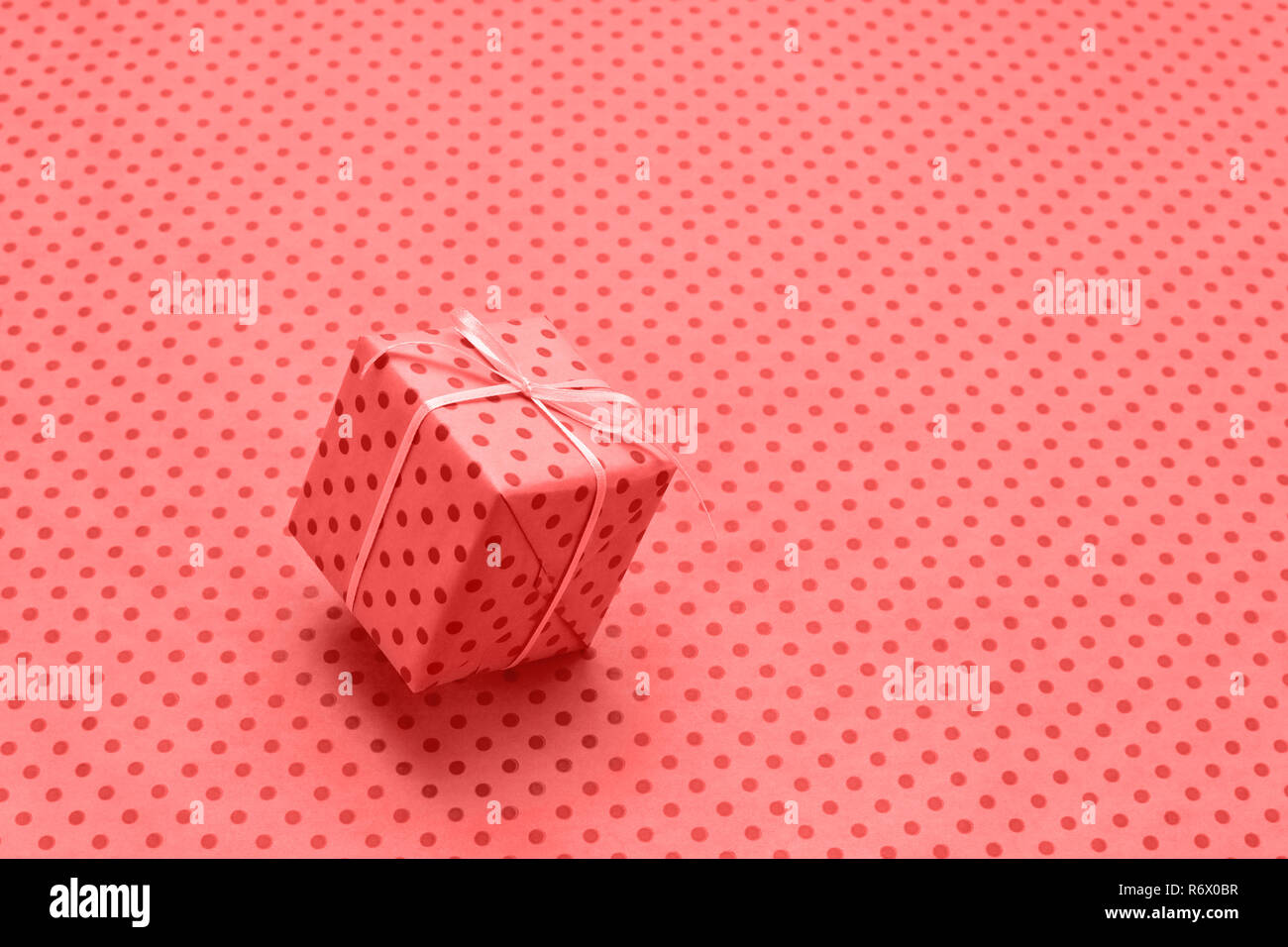 Living Coral color of the Year 2019, Gift box in motion on wrapping ...