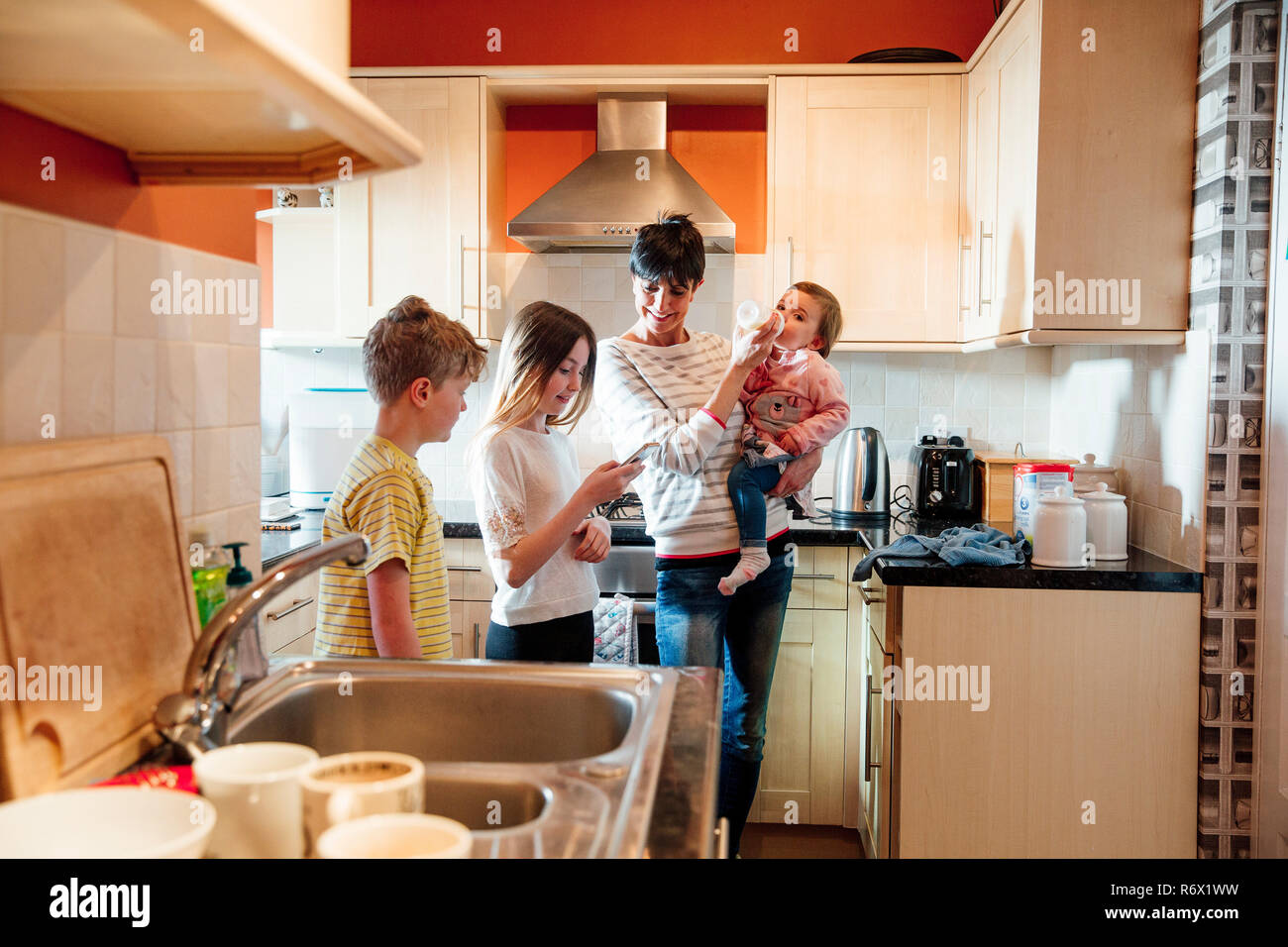 Family Socialising in the Kitchen Stock Photo - Alamy