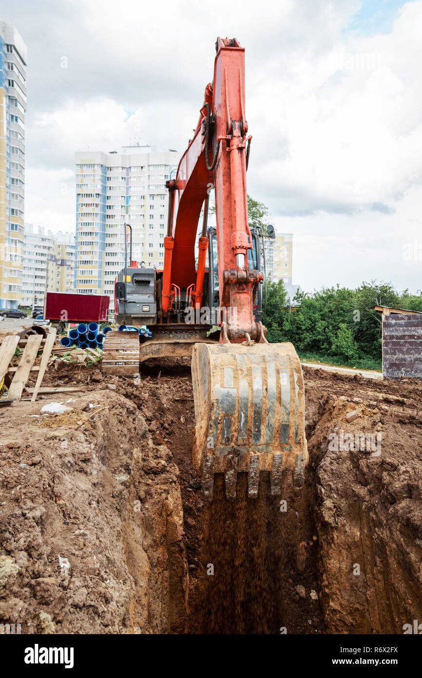 Excavator working on a construction site. Digging the trench for the ...