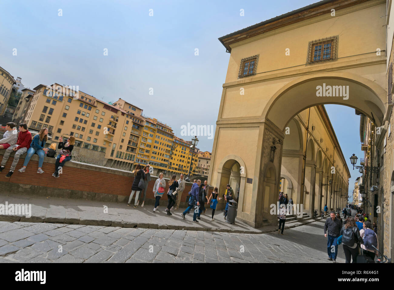 Horizontal view of tourists walking underneath the Vasari Corridor in ...