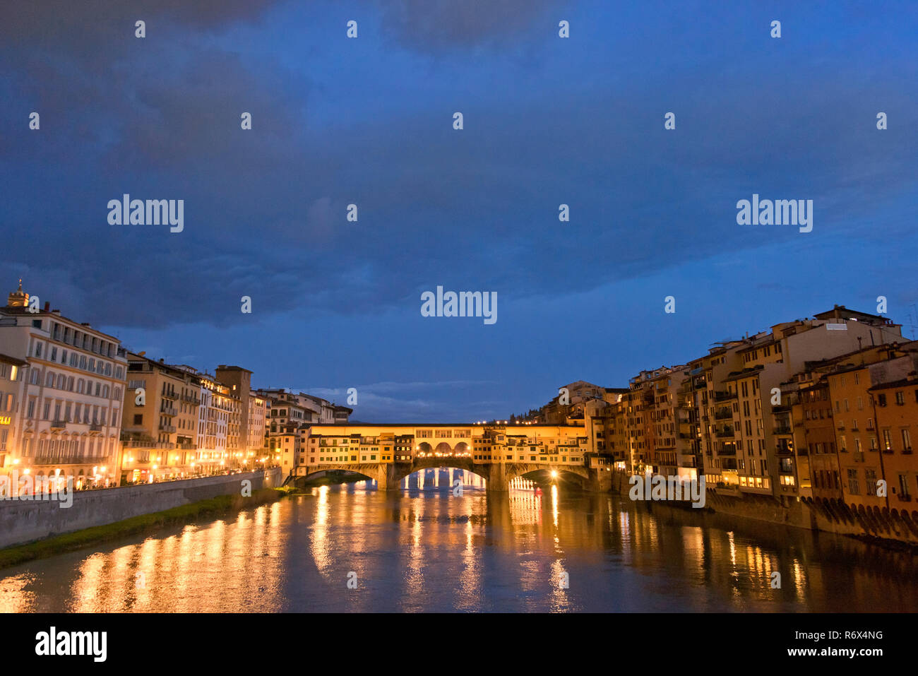 Horizontal view of the Ponte Vecchio lit up at night in Florence, Italy ...