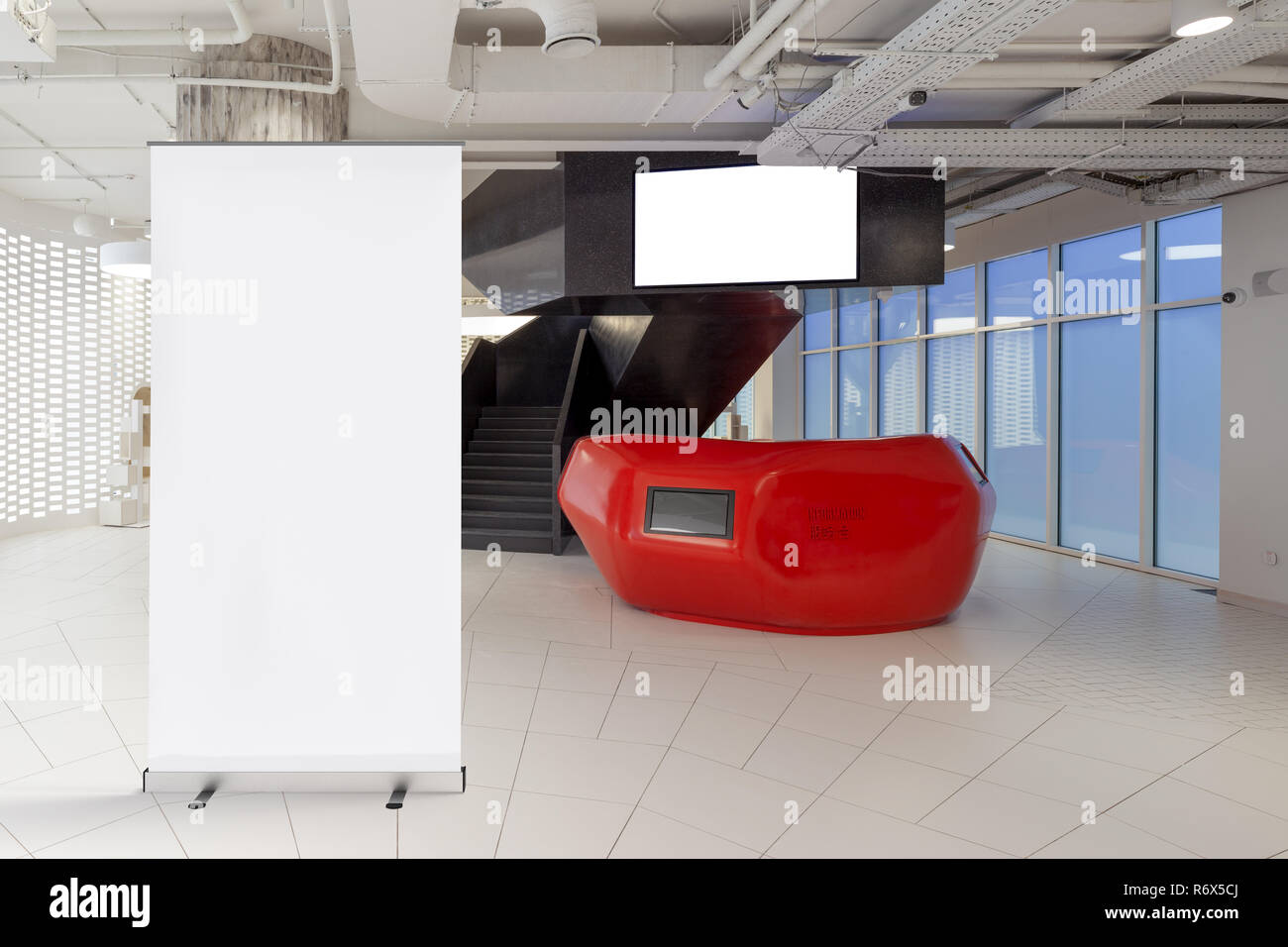 Blank roll up banner stand and reception desk in contemporary office ...