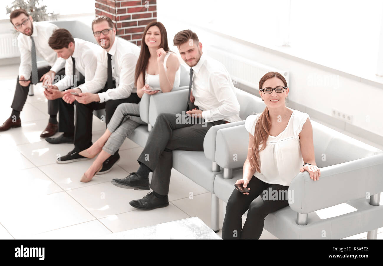 group of employees sitting in the lobby of a modern office Stock Photo ...