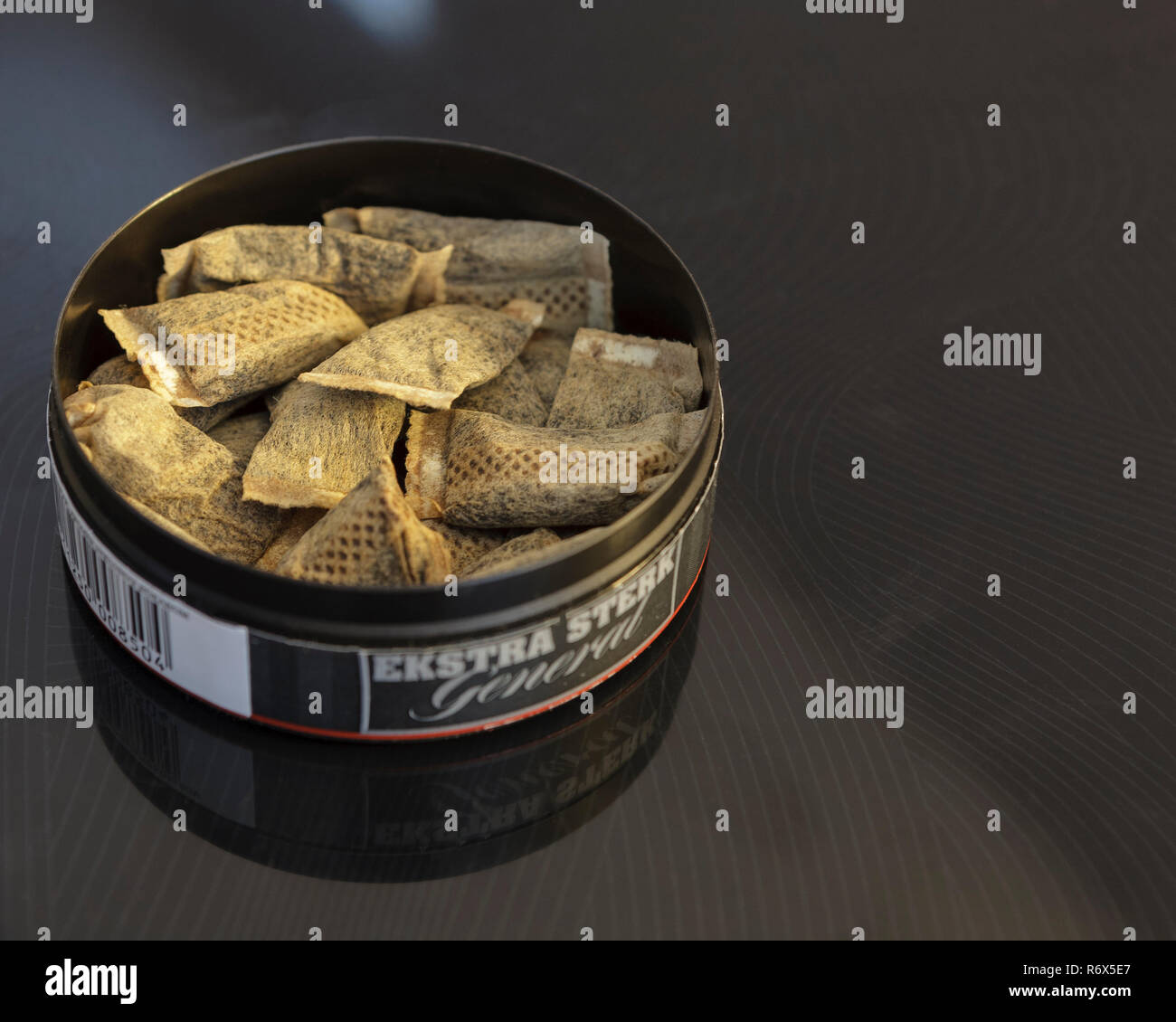 Close up of plastic tin of pouches of typically Swedish snus. Snus is a ...