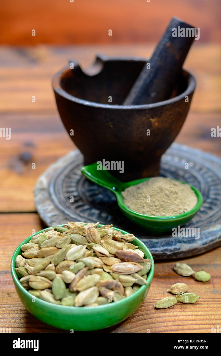 Bowl with cardamom pots and cardamom powder, used for cooking and ...