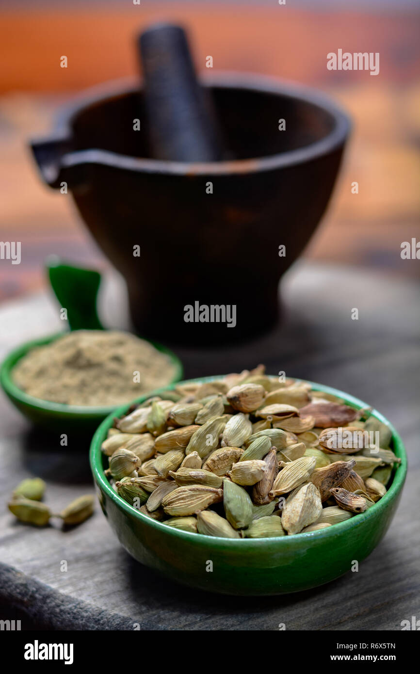 Bowl with cardamom pots and cardamom powder, used for cooking and ...