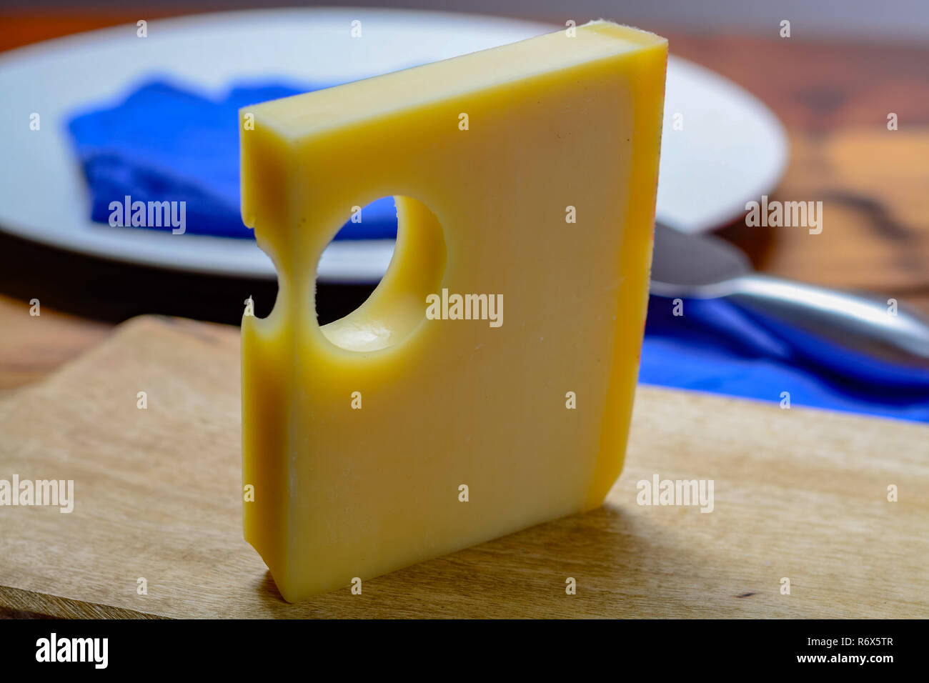 Block of Swiss Emmental or Emmentaler medium-hard cheese with round ...