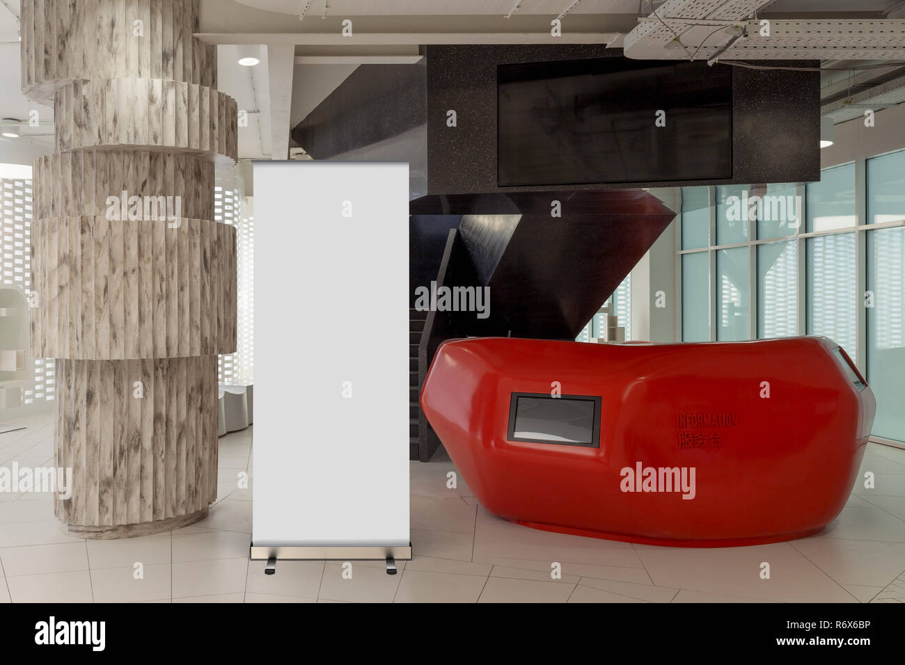 Blank roll up banner stand in office interior with reception desk and ...
