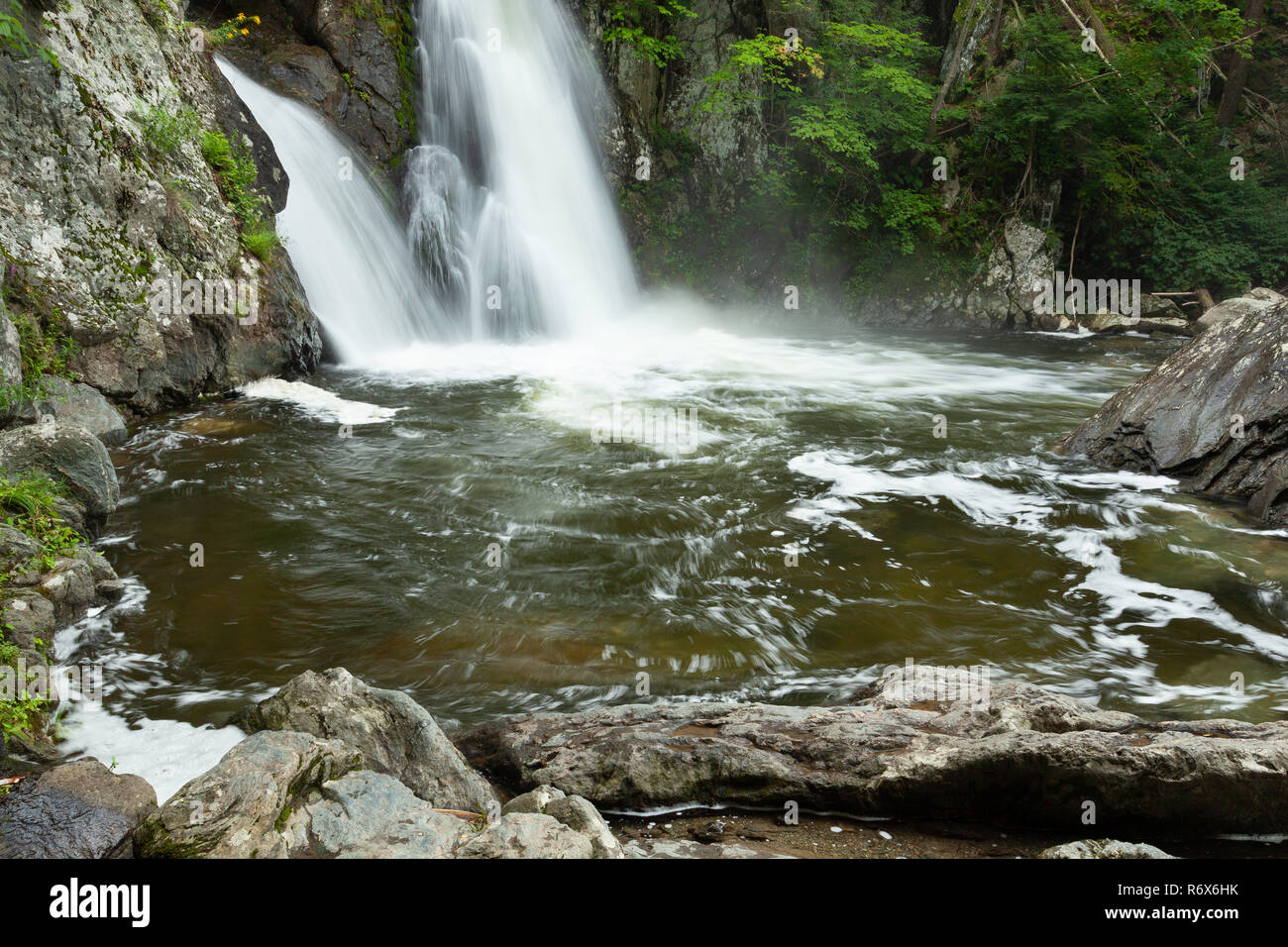 Bash Bish Falls pouring into a large pool at the base of the waterfall ...