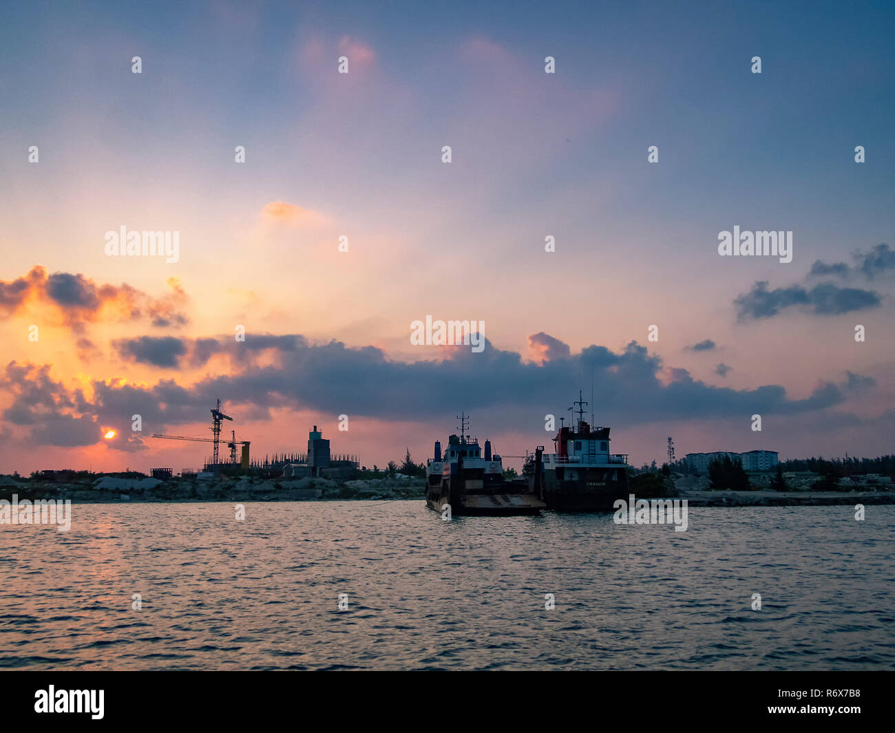Sunrise and the silhouette of the skyline of Male in the Maldives Stock ...