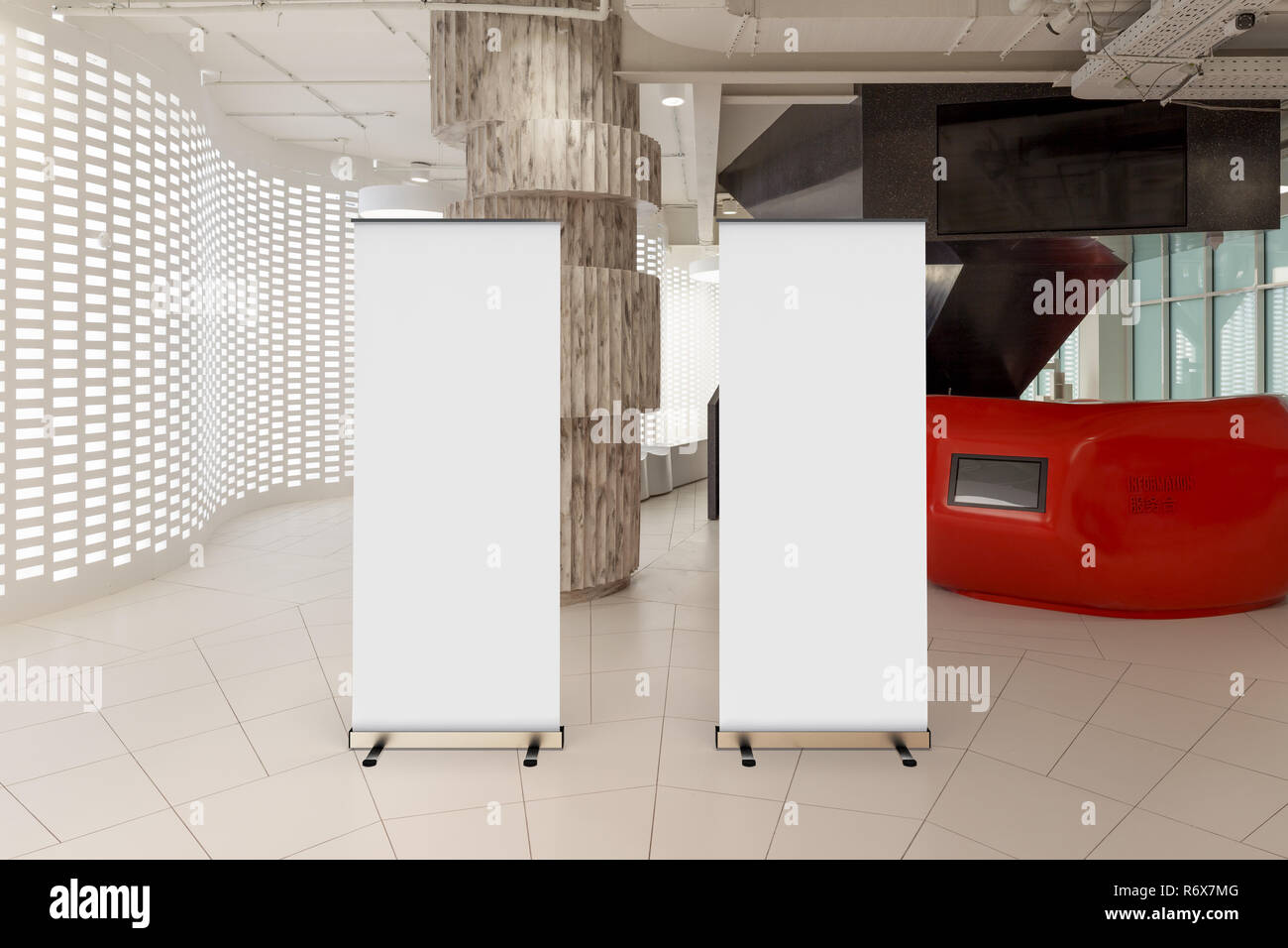 Two blank roll up banner stand in office interior with reception desk ...