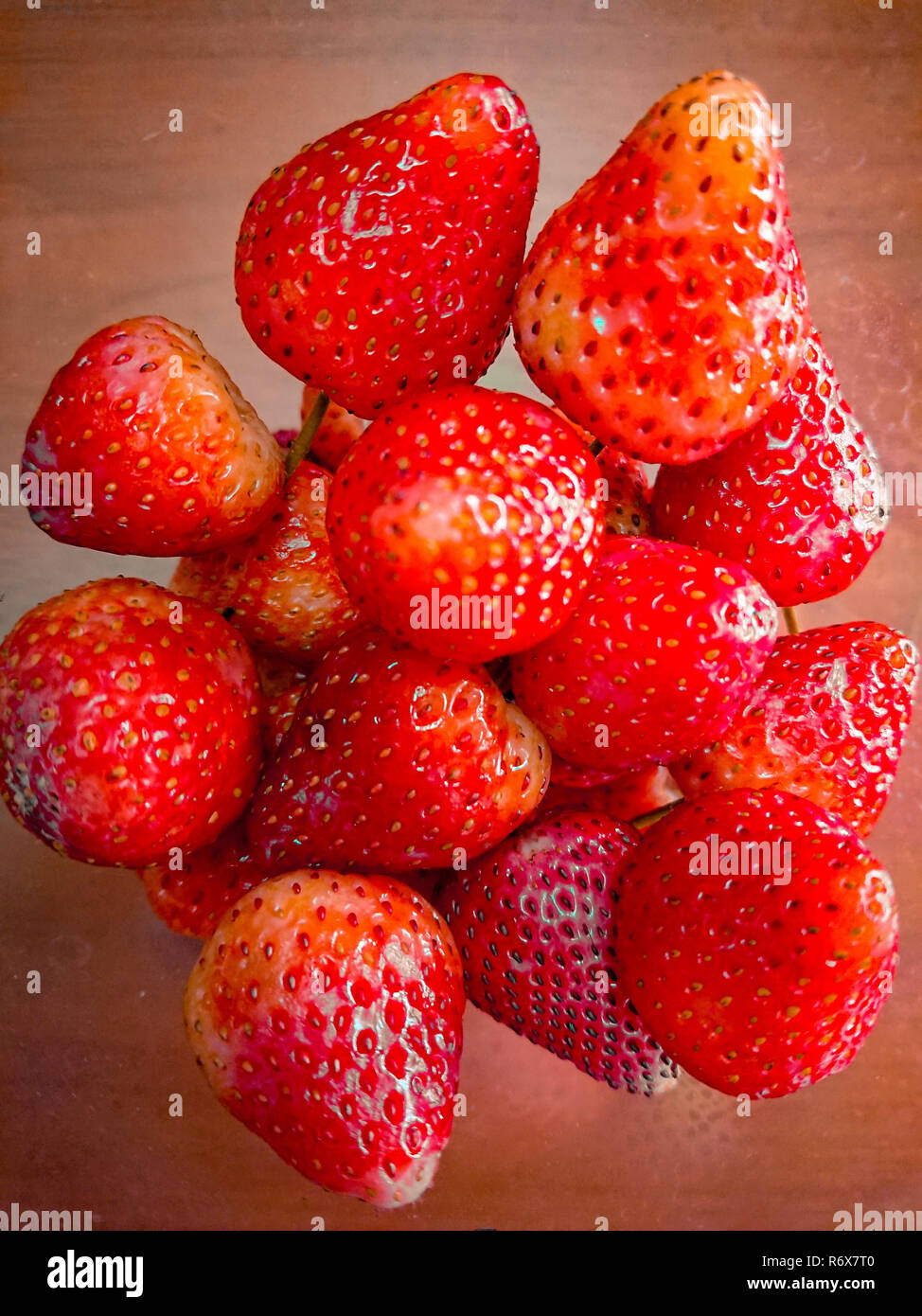 Strawberry on a wood table.Strawberry group Stock Photo - Alamy
