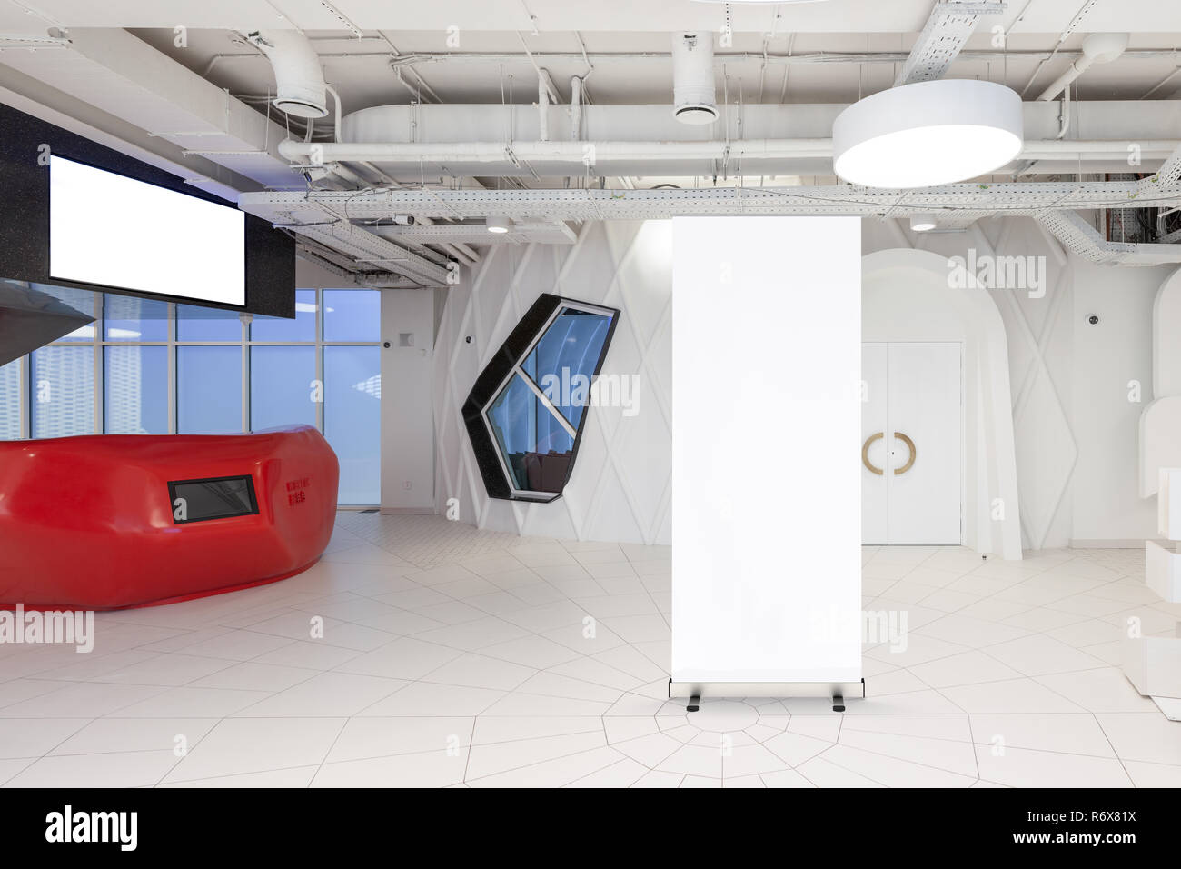 Blank roll up banner stand in contemporary office lobby interior with ...