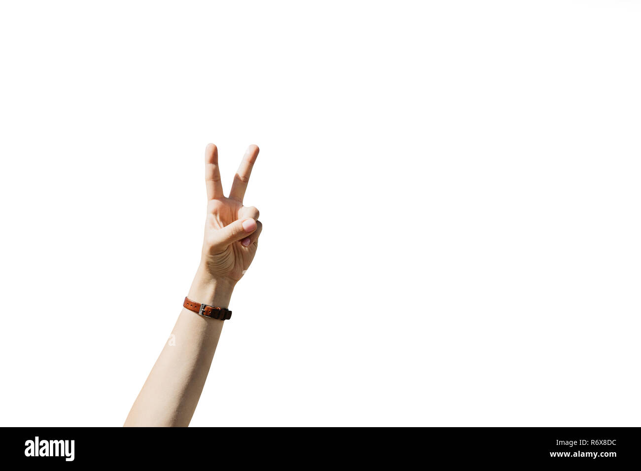 Girl shows peace sign on a white background Stock Photo - Alamy